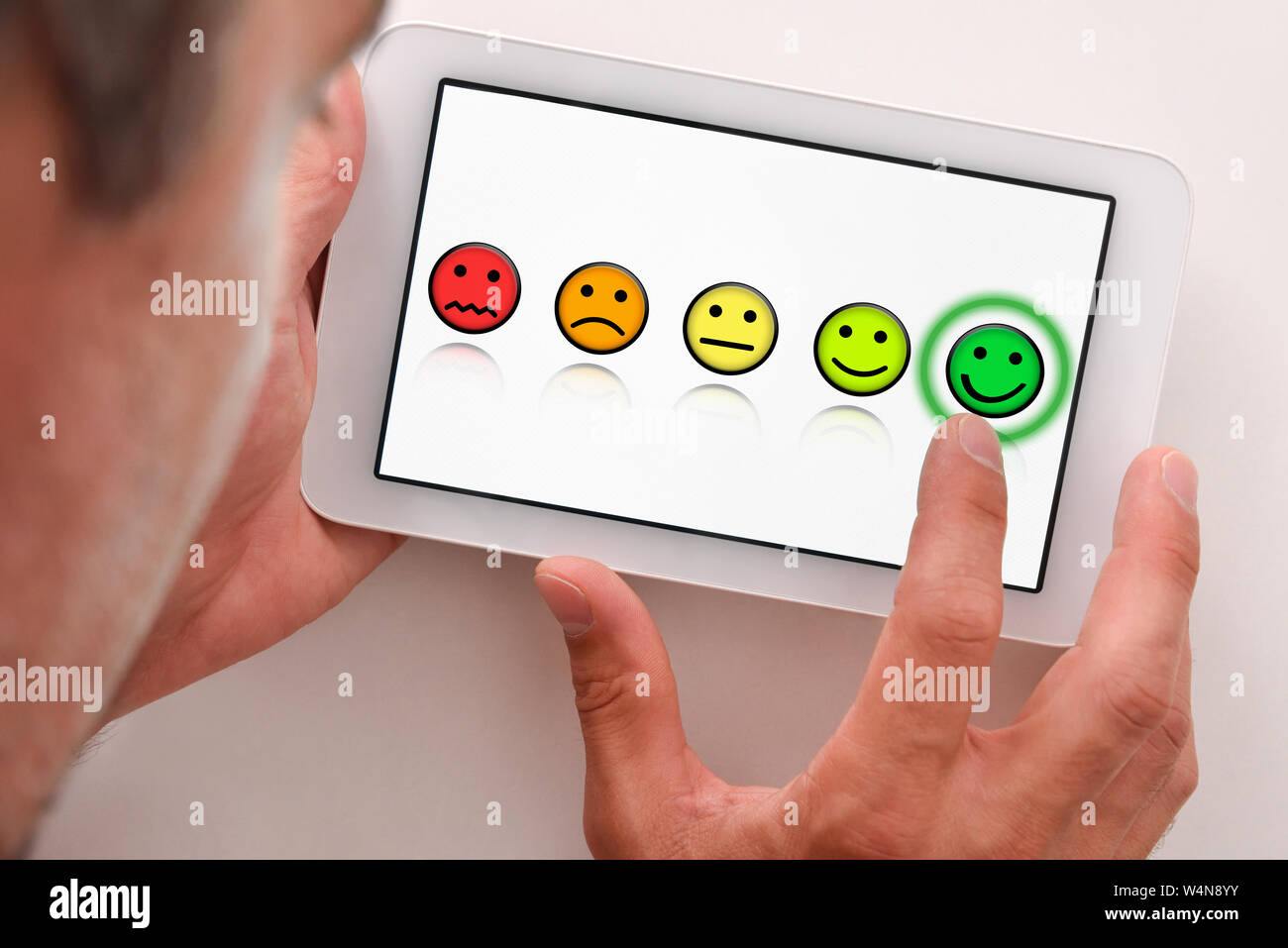 Man providing a positive assessment on an electronic device. Horizontal ...