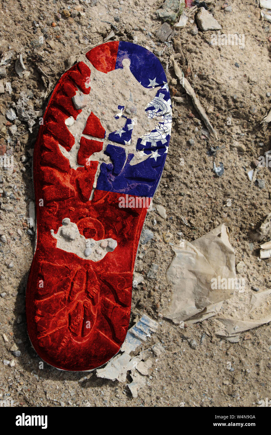 The flag of Myanmar Burma is depicted on the sole of an old boot ...