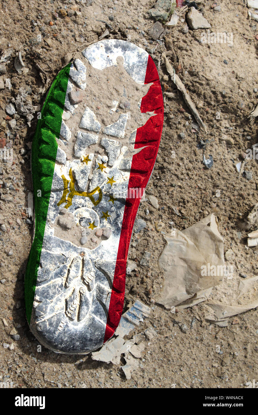 The flag of Tajikistan is depicted on the sole of an old boot. Ecology ...