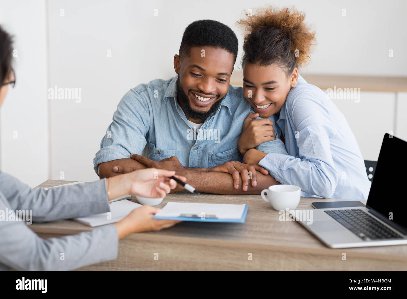 Family and adoption counseling. Excited african american couple sitting ...