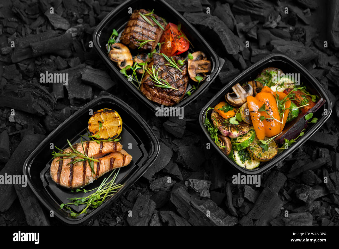 Freshly cooked Grilled menu for take away in black boxes Stock Photo ...