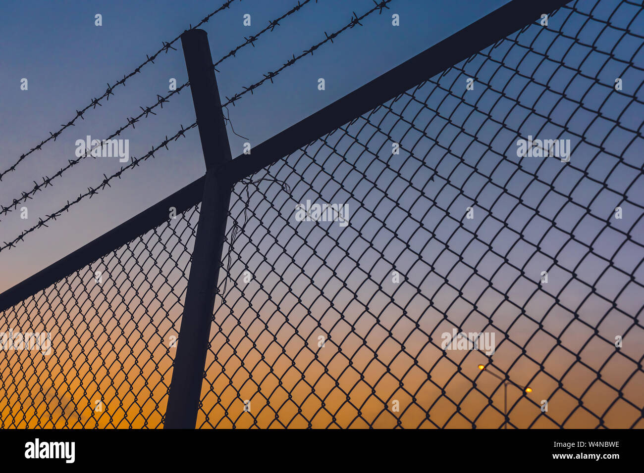 dusk twilight evening sky with fences and barbed wire wire Stock Photo ...