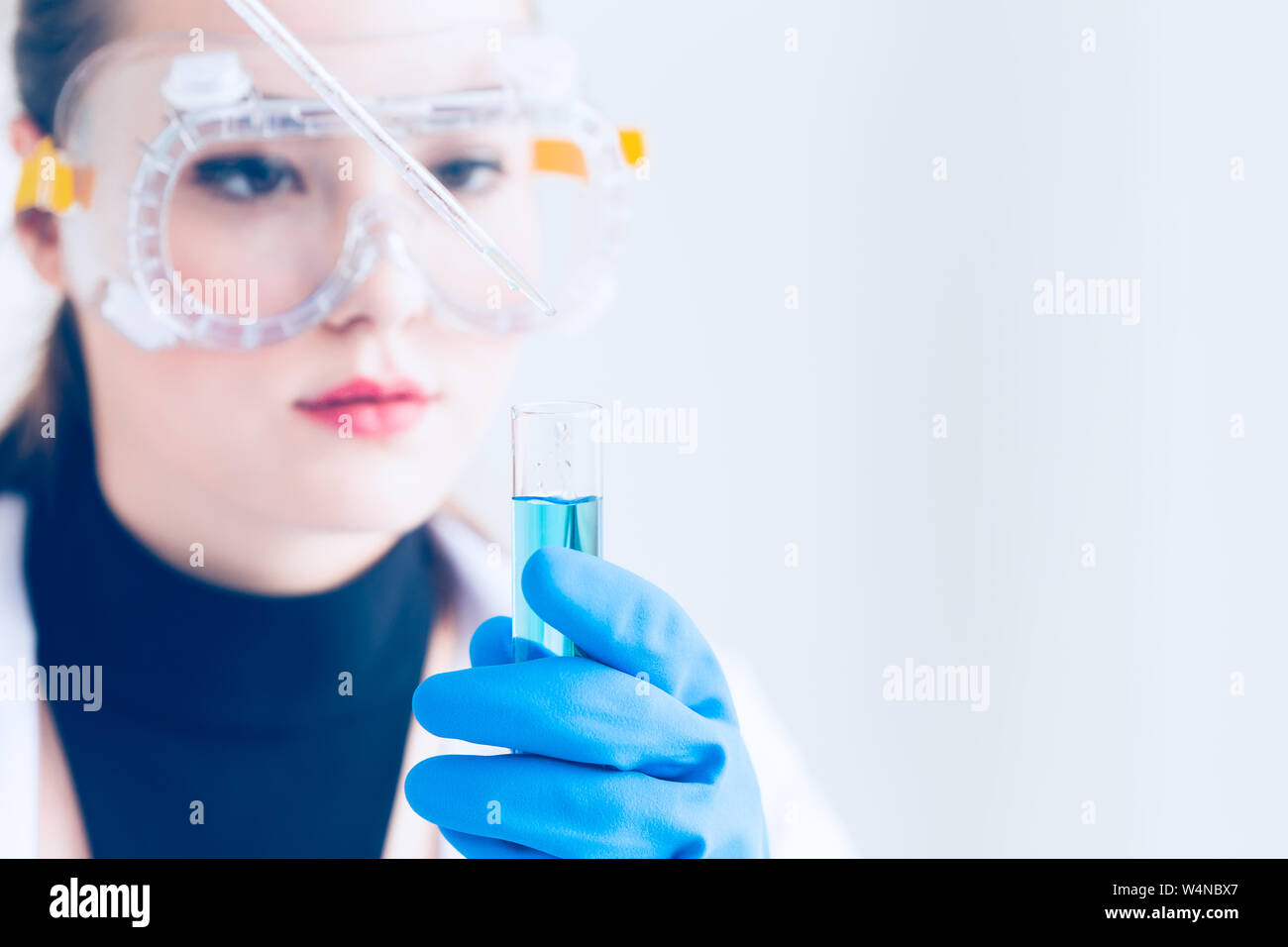 Beautiful scientist model with chemical research drop test in hospital ...