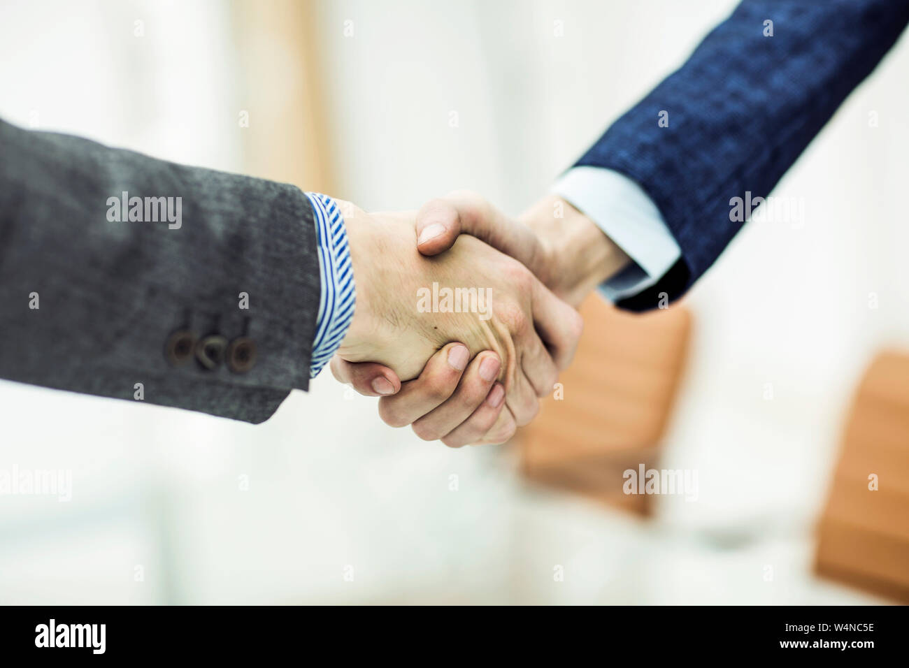 handshake of business partners on blurred light background.the photo ...