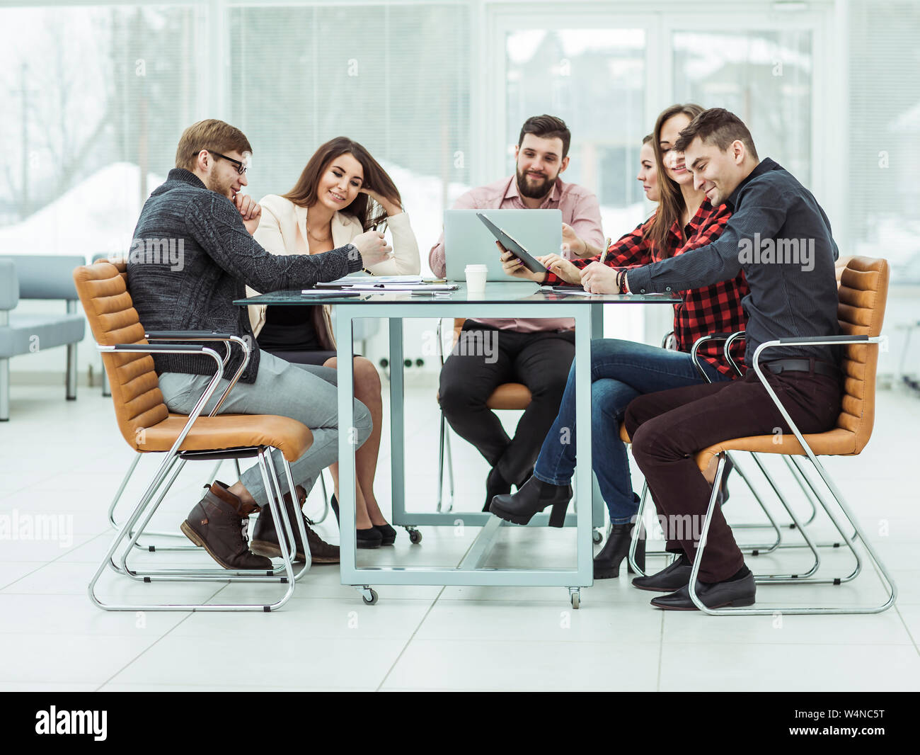 successful business team discussing work documents sitting behind a ...