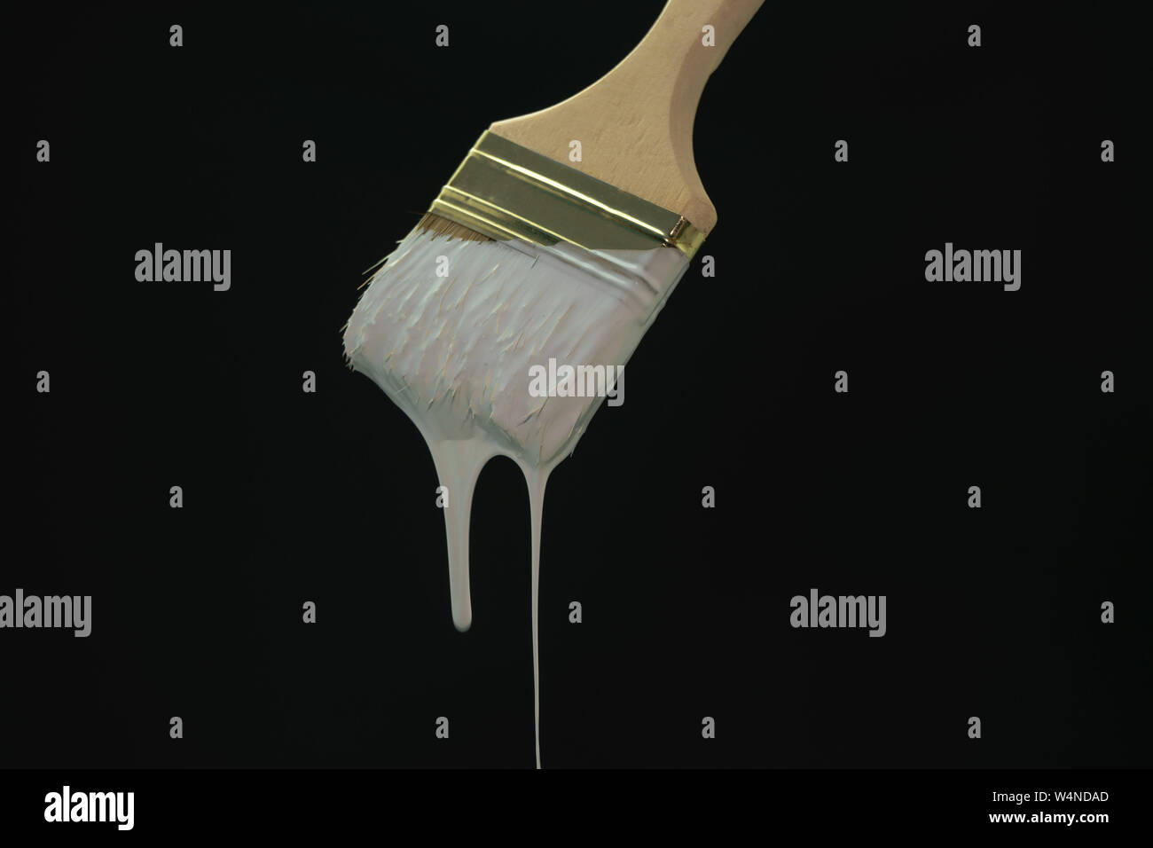 Dripping white paint brush on a blackbackground Stock Photo - Alamy