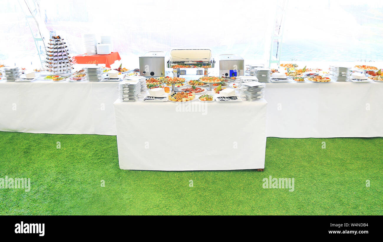 catering table set service with silverware and glass stemware at ...