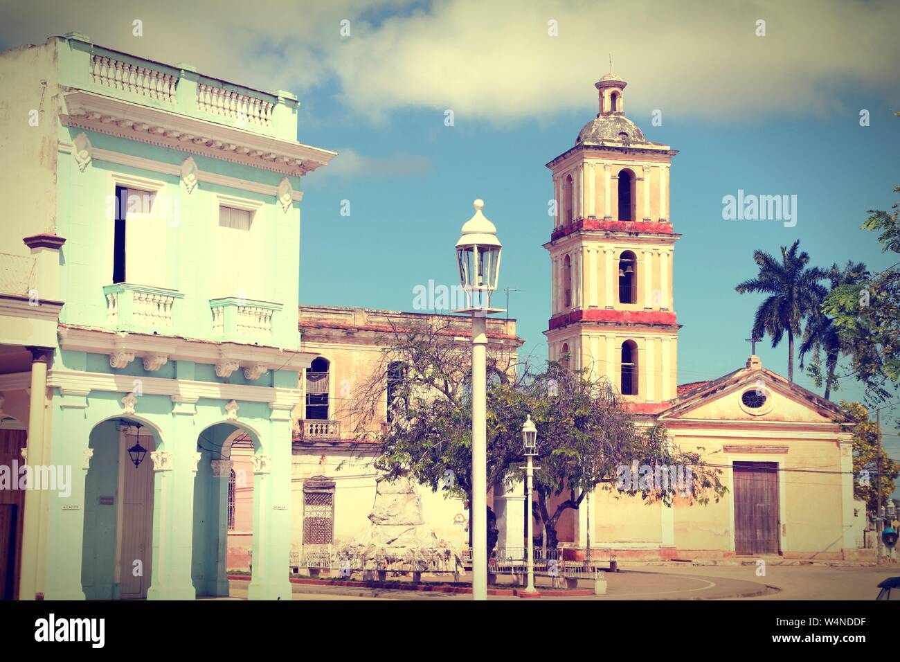 Remedios, Cuba - main square palm trees and church. Cross processed ...