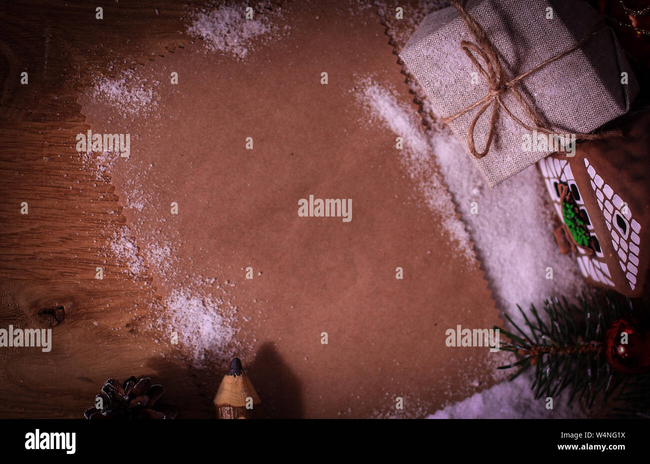 Christmas gift and blank sheet for greetings on a festive background ...