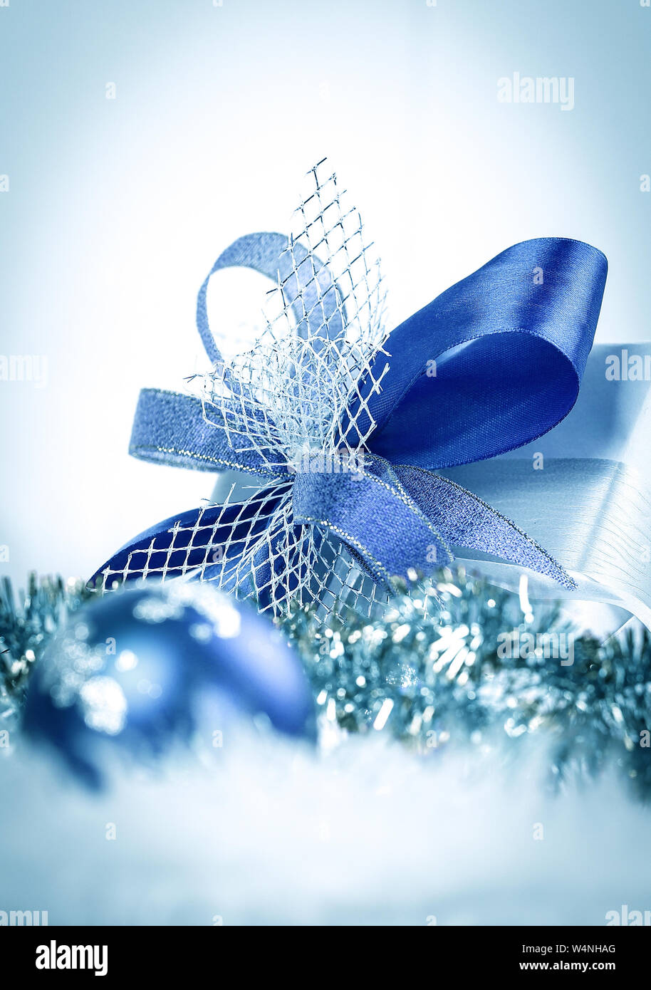 Christmas gift and blue Christmas balls on a festive white background ...