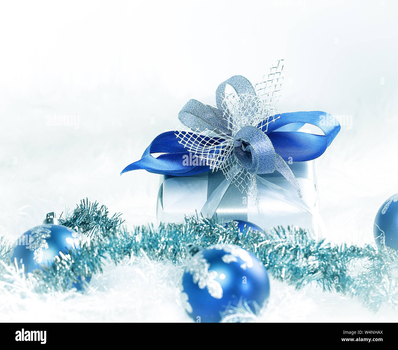 Christmas gift and blue Christmas balls on a festive white background ...