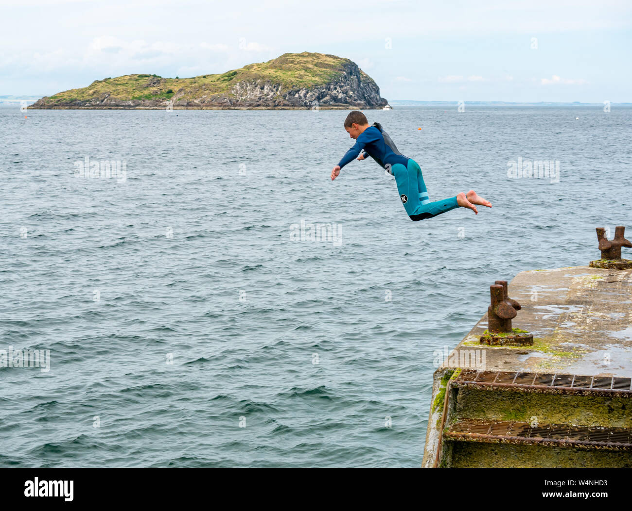 Boy diving off pier in hi-res stock photography and images - Alamy