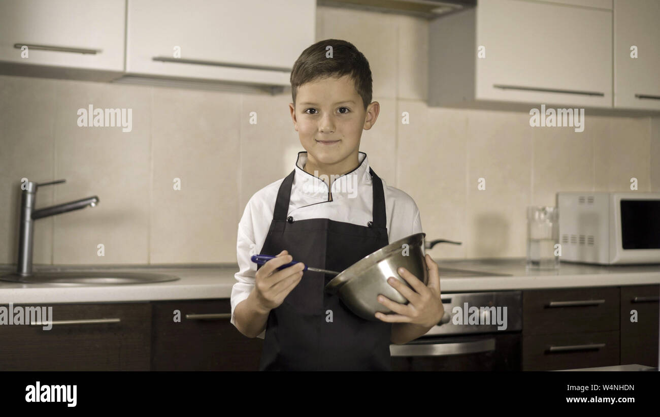 The little boy in a suit of the cook. Baby make dinner in chef suit ...