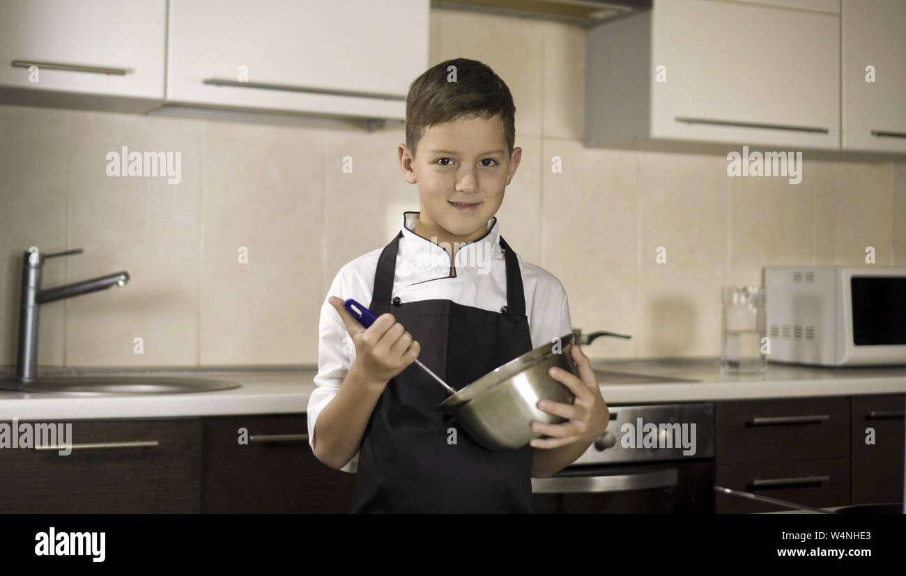 The little boy in a suit of the cook. Baby make dinner in chef suit ...