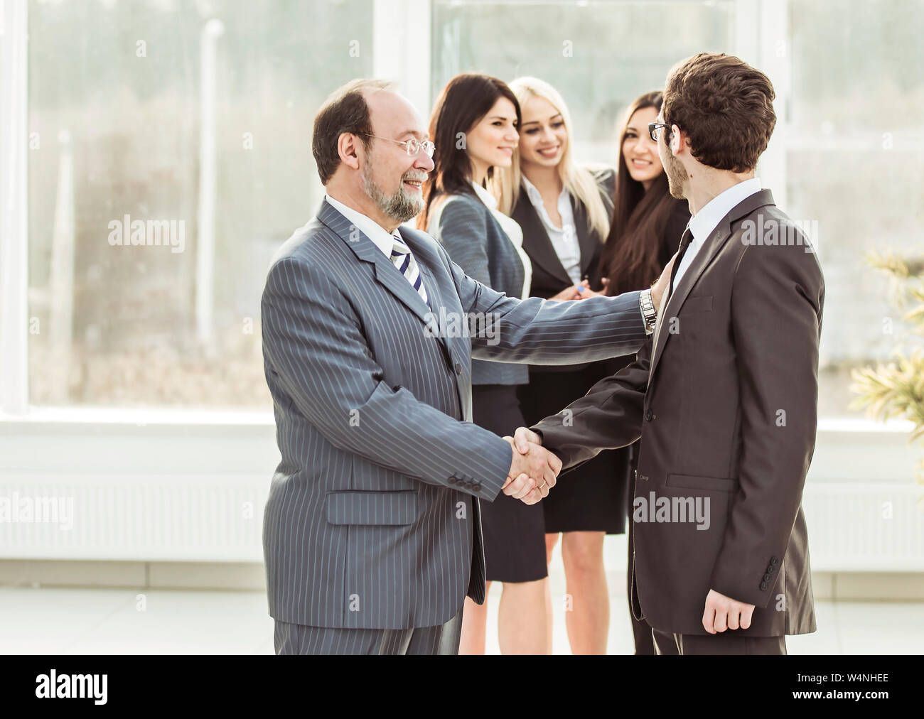 handshake colleagues in the spacious lobby of the office.the photo has ...