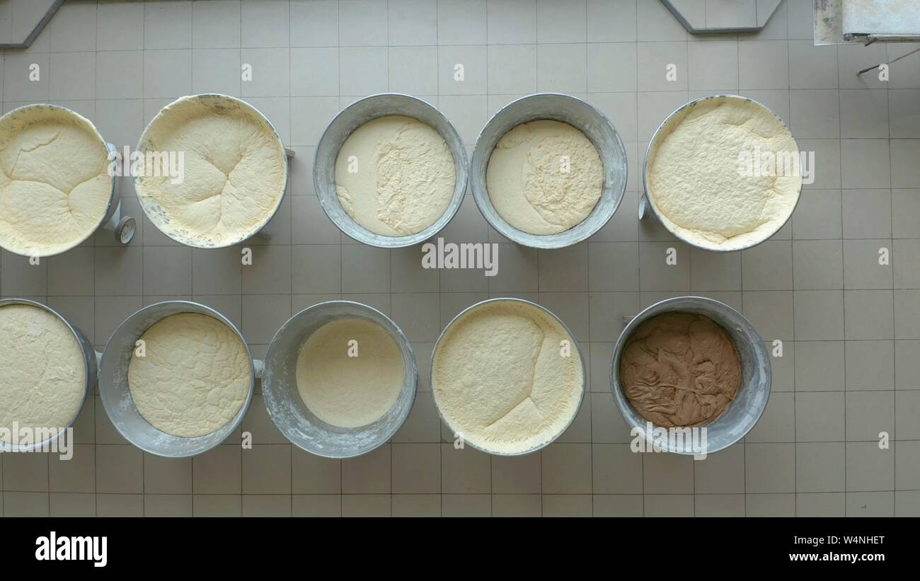 Closeup of yeast dough in production. yeast dough preparation process ...