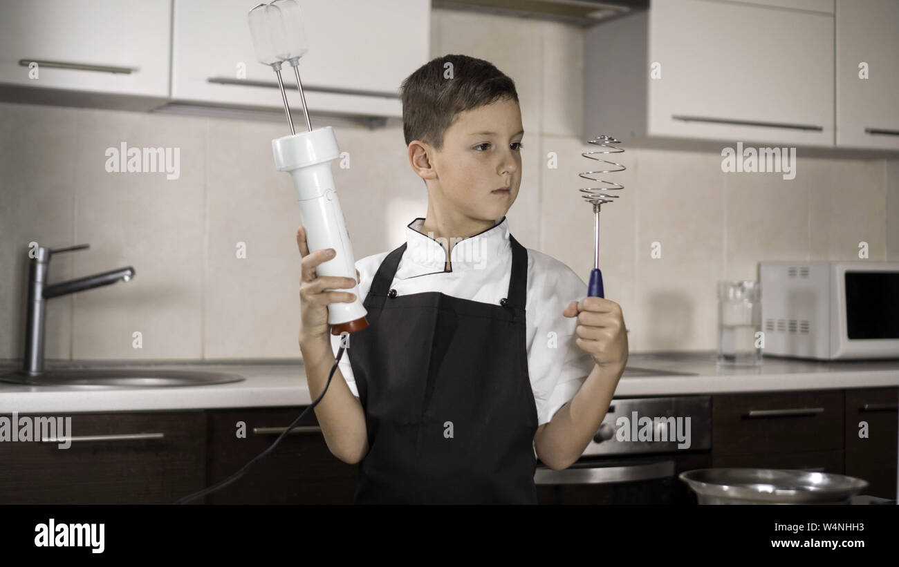 The little boy in a suit of the cook. Baby make dinner in chef suit ...