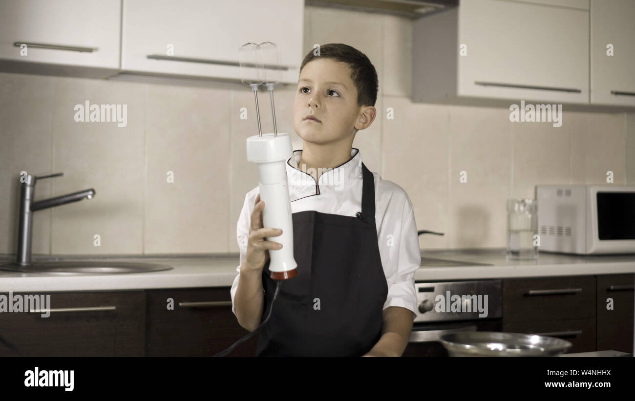 The little boy in a suit of the cook. Baby make dinner in chef suit ...