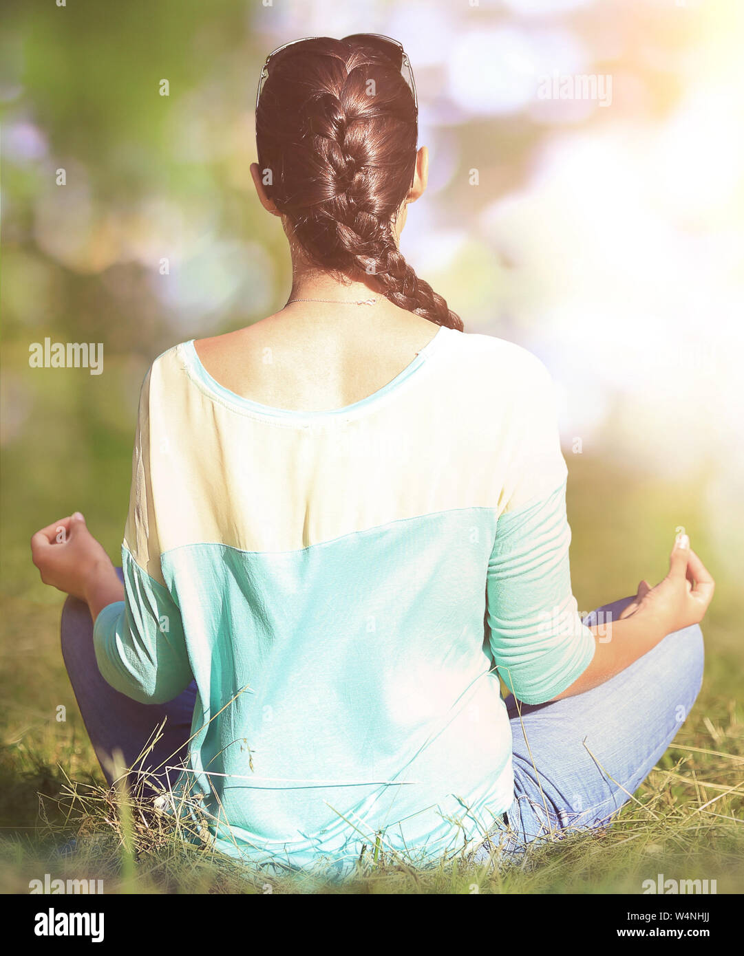 Attractive young woman in the a lotus position Stock Photo - Alamy