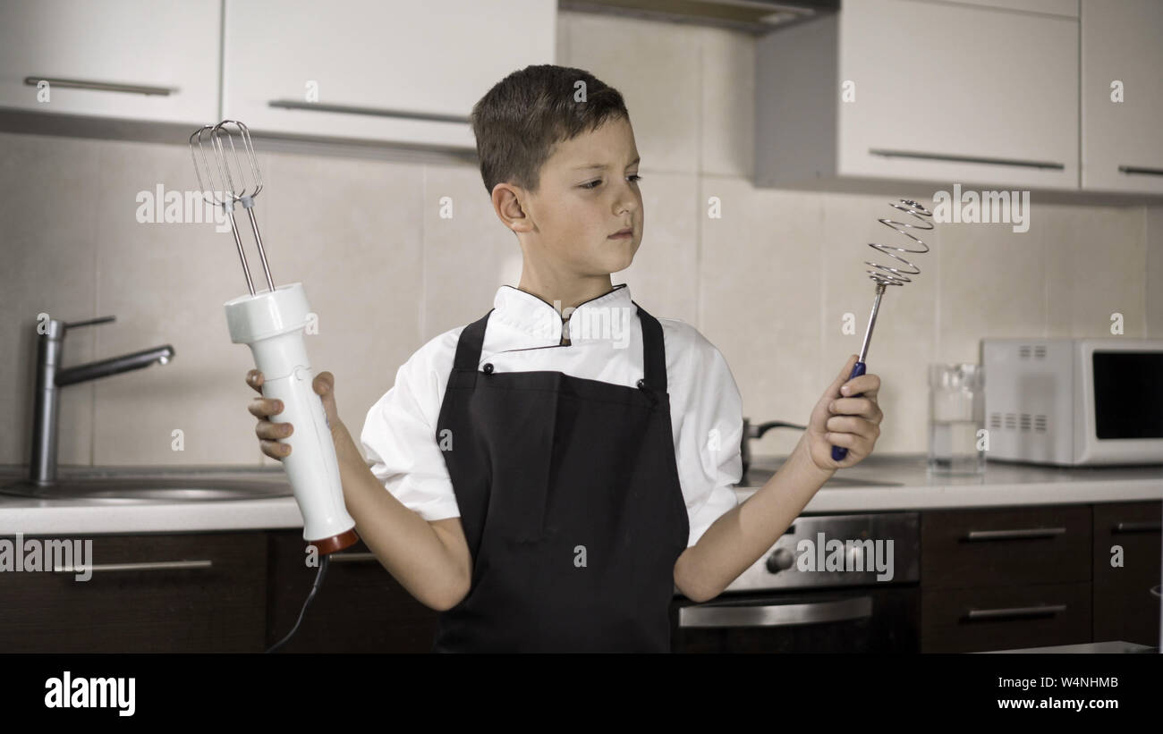 The little boy in a suit of the cook. Baby make dinner in chef suit ...