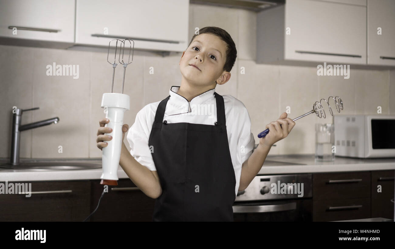 The little boy in a suit of the cook. Baby make dinner in chef suit ...