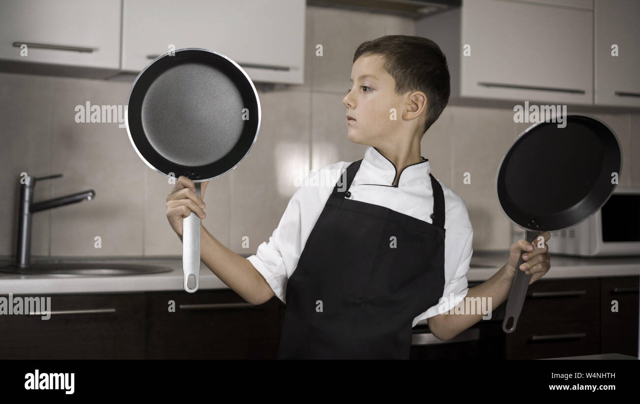 The little boy in a suit of the cook. Baby make dinner in chef suit ...