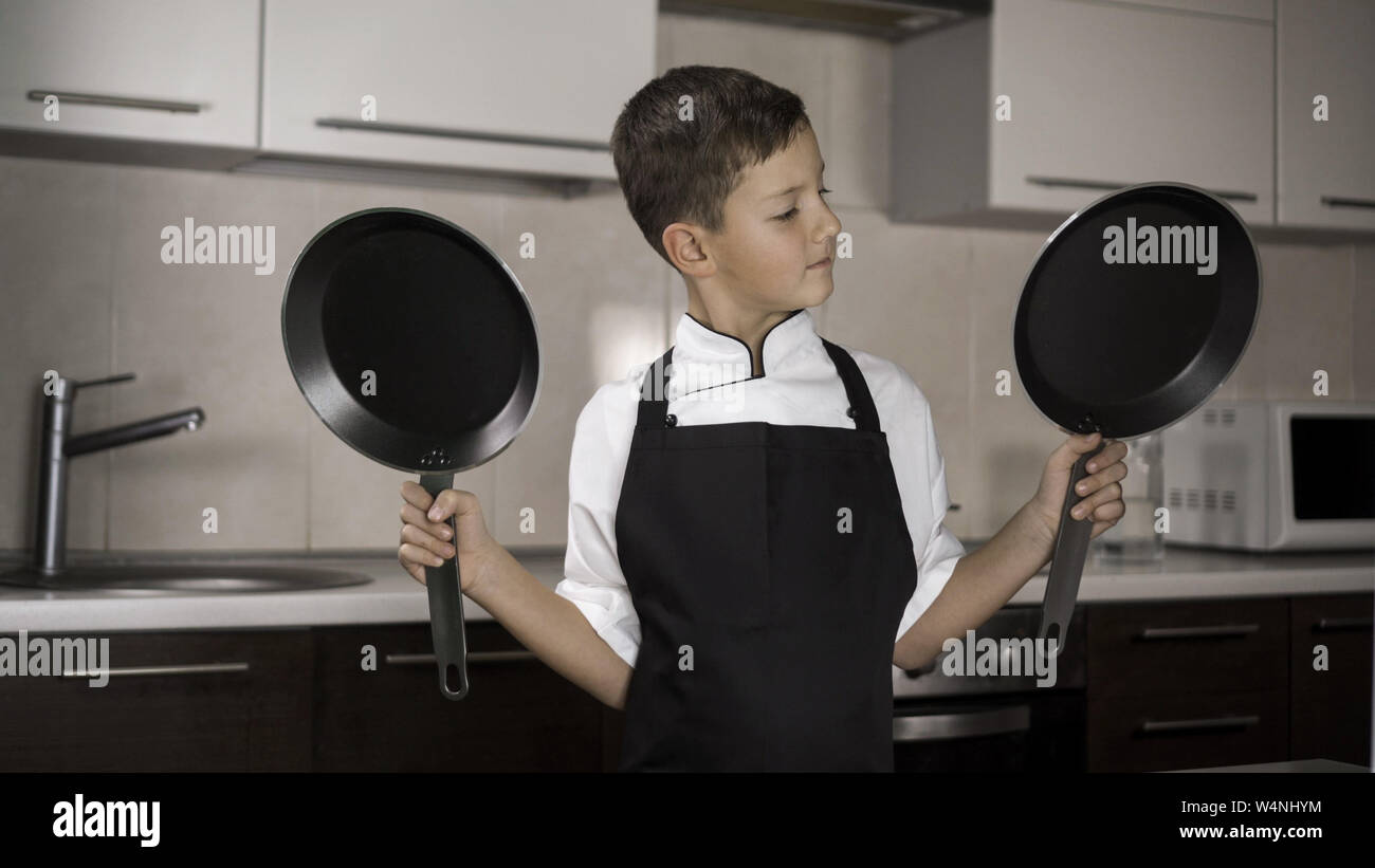 The little boy in a suit of the cook. Baby make dinner in chef suit ...