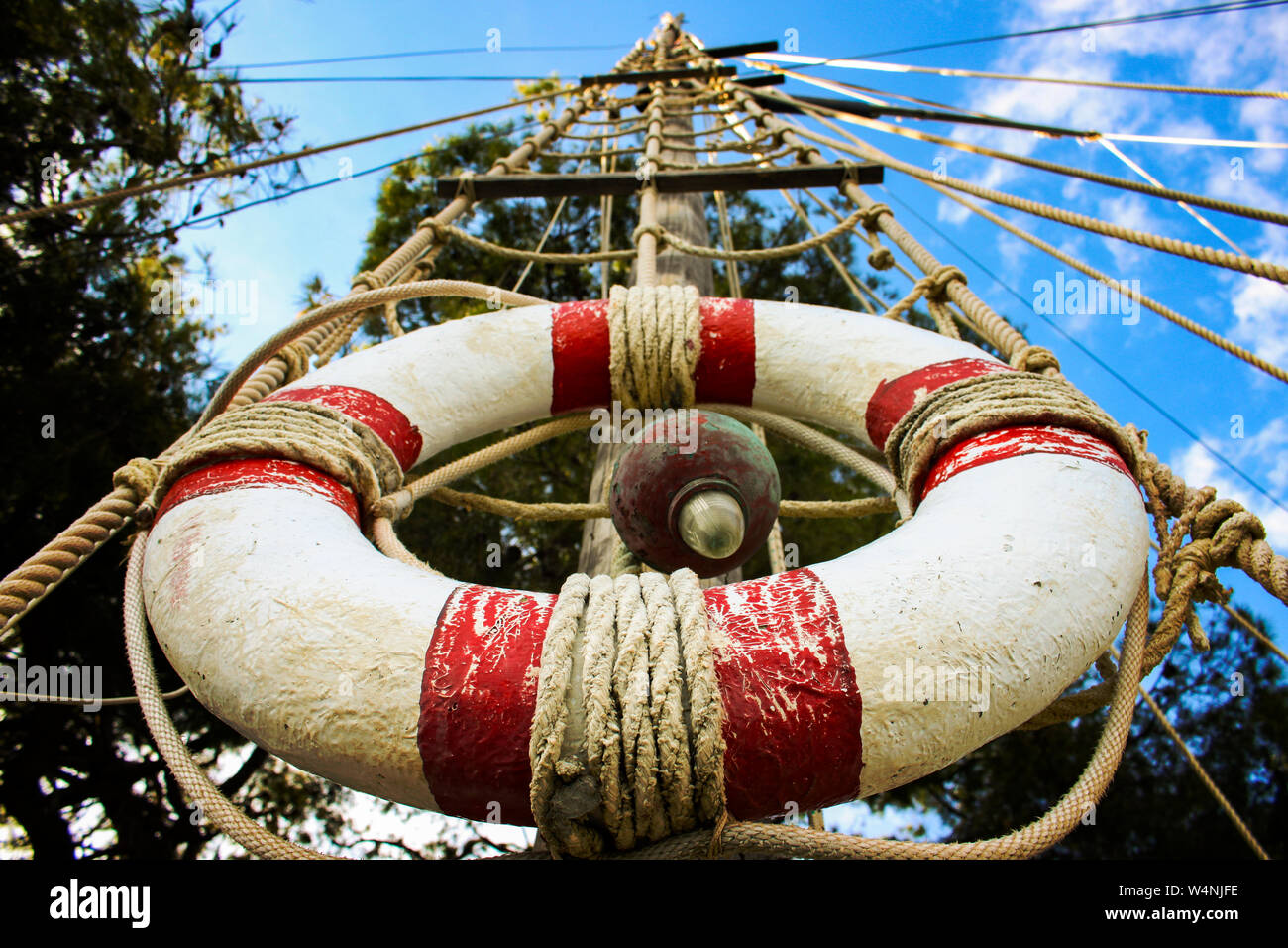 Lifebelt on the wooden mast tied with cord or a rope view from the ...