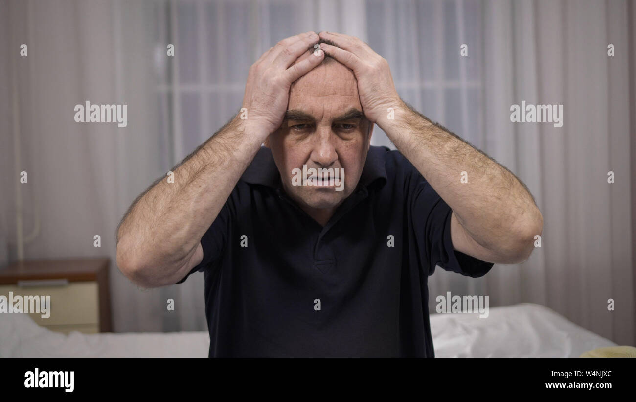 Elderly man with a headache. Age related health problems Stock Photo ...