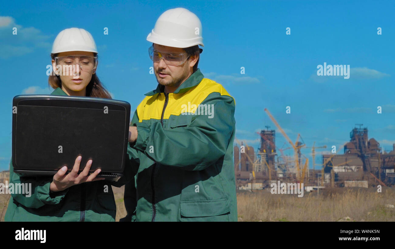 Workers in production plant as team discussing, industrial scene in ...