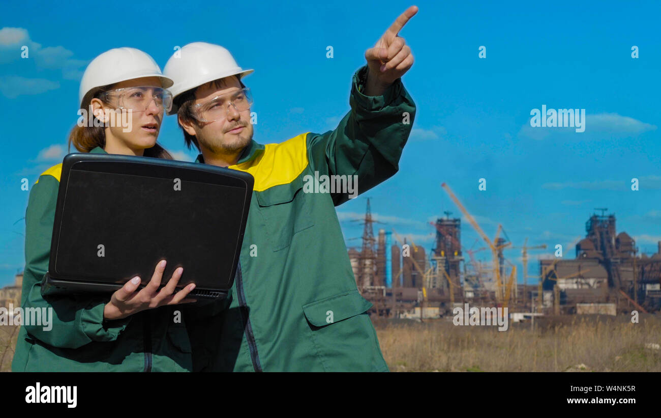 Workers in production plant as team discussing, industrial scene in ...