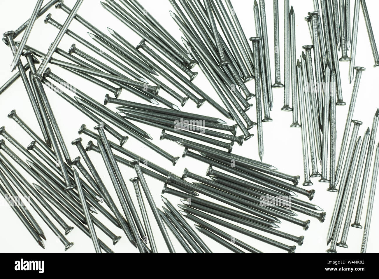 Pile of iron nails at white background Stock Photo - Alamy