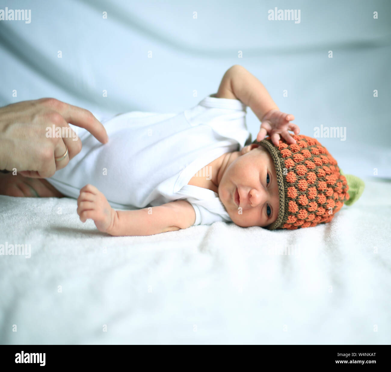caring hand of a mother caressing a newborn baby.the photo has a empty ...