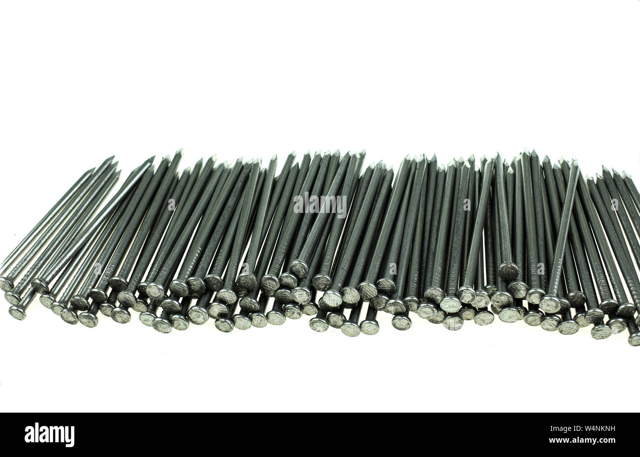 Pile of iron nails at white background Stock Photo - Alamy