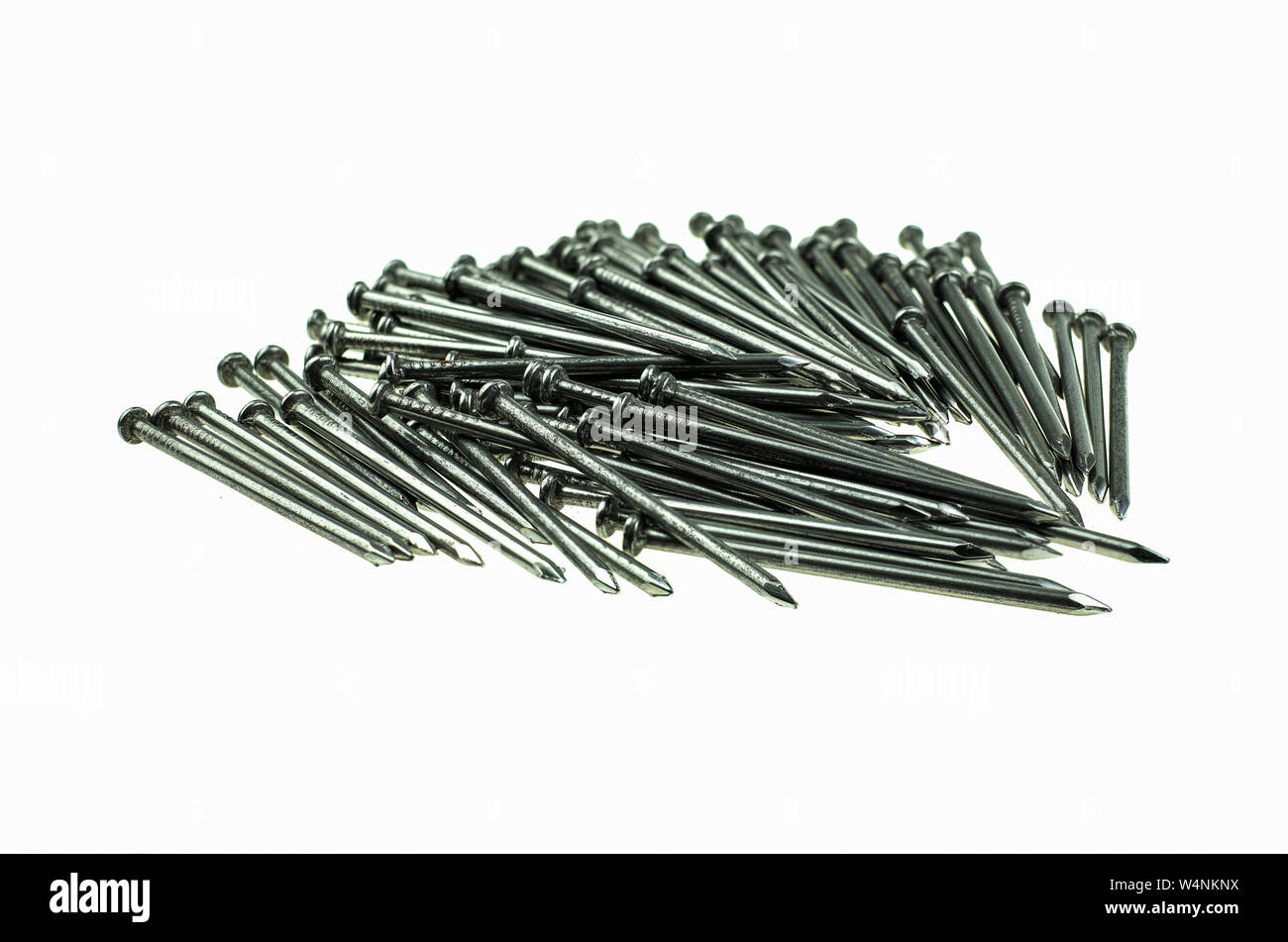 Pile of iron nails at white background Stock Photo - Alamy