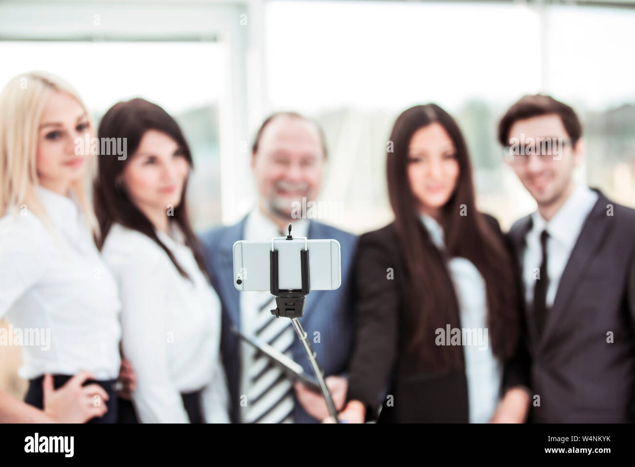 business team is doing a selfie with her Manager standing near the ...