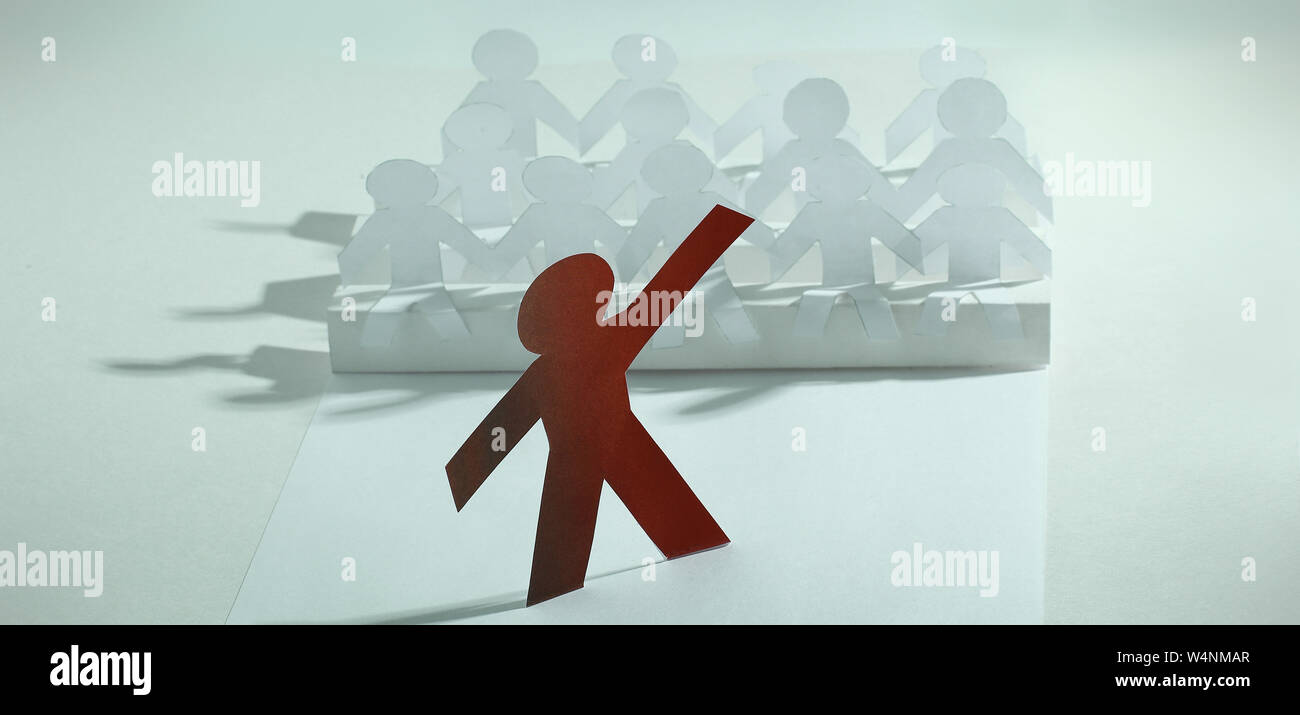 leader standing in front of a group of paper doll. photo with copy ...