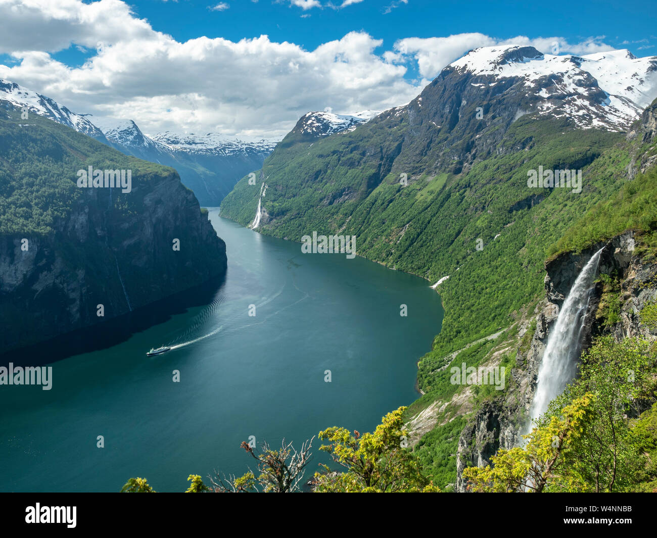 Panoramic view of the Geirangerfjord on a sunny spring day, boats on ...