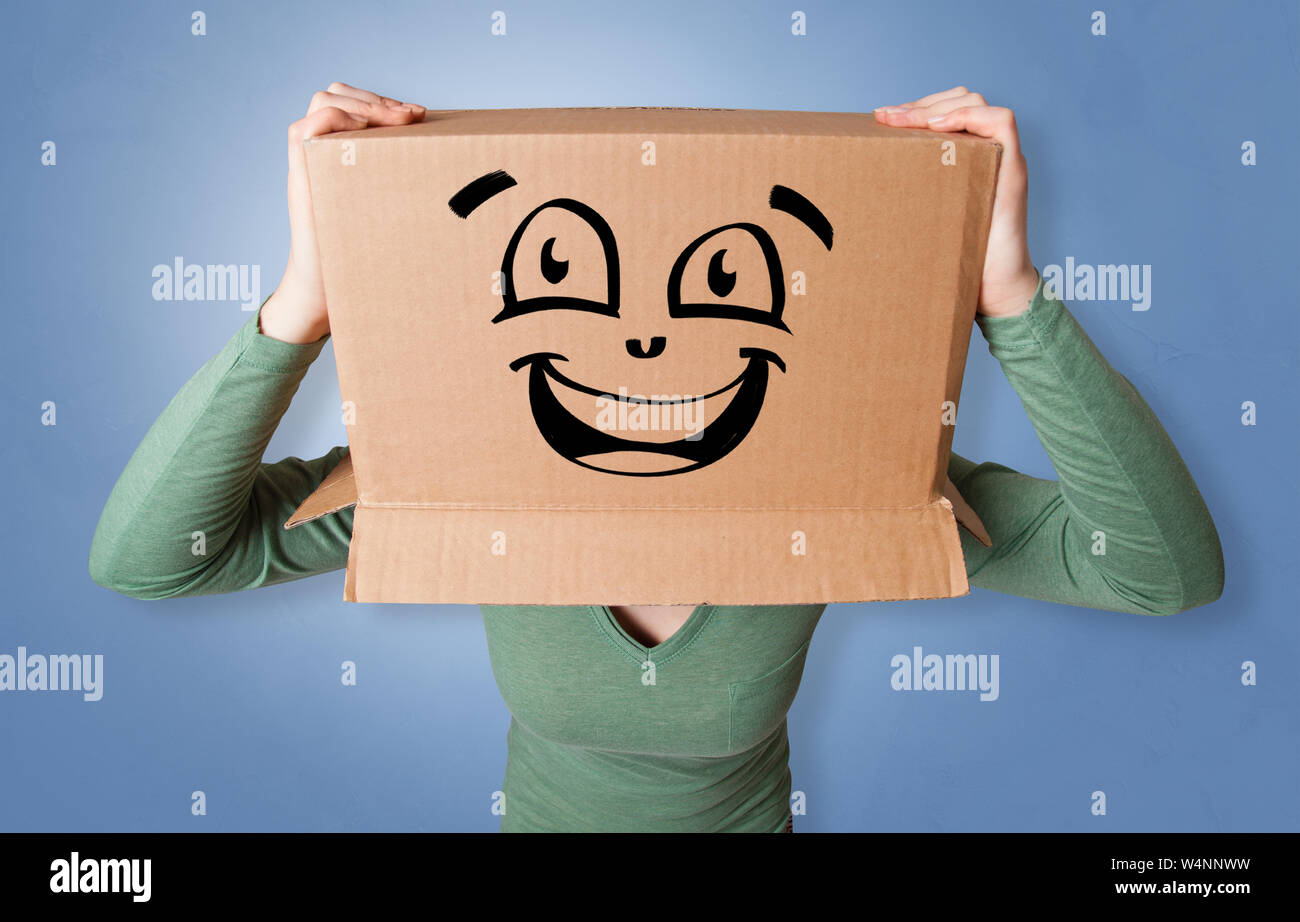 Young woman with happy face illustrated cardboard box on her head Stock ...