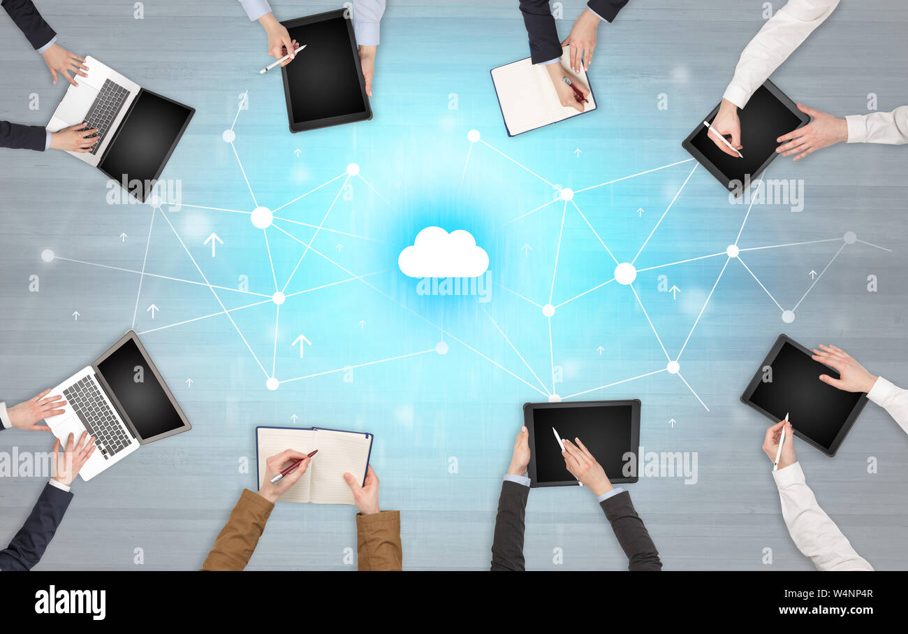 Group of people with devices in hands working in team on tablets ...