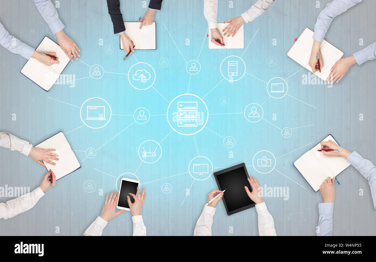 Group of people with devices in hands working in team on tablets ...