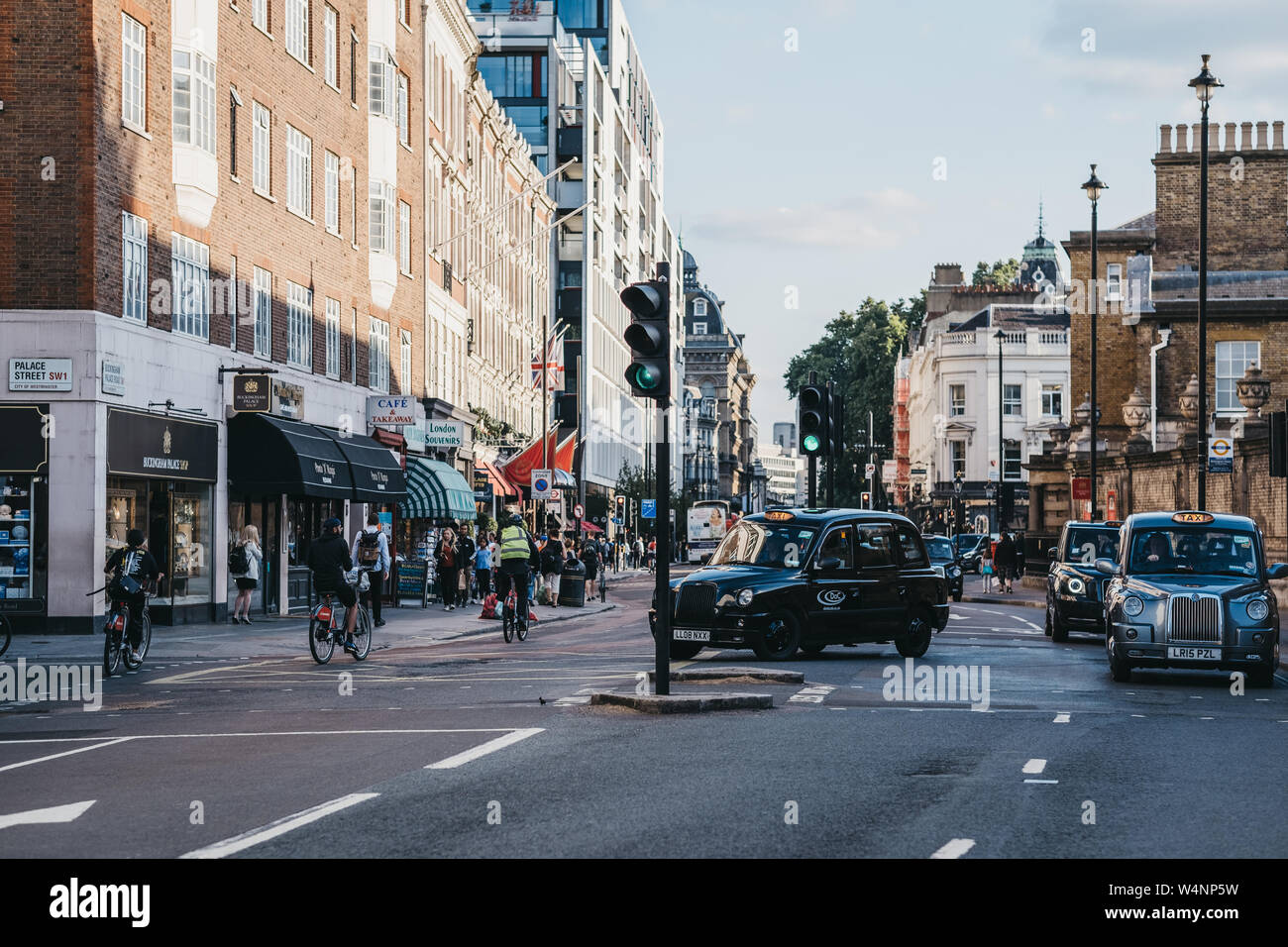London, UK - July 15, 2019: Blacks cabs and cyclists on Buckingham ...