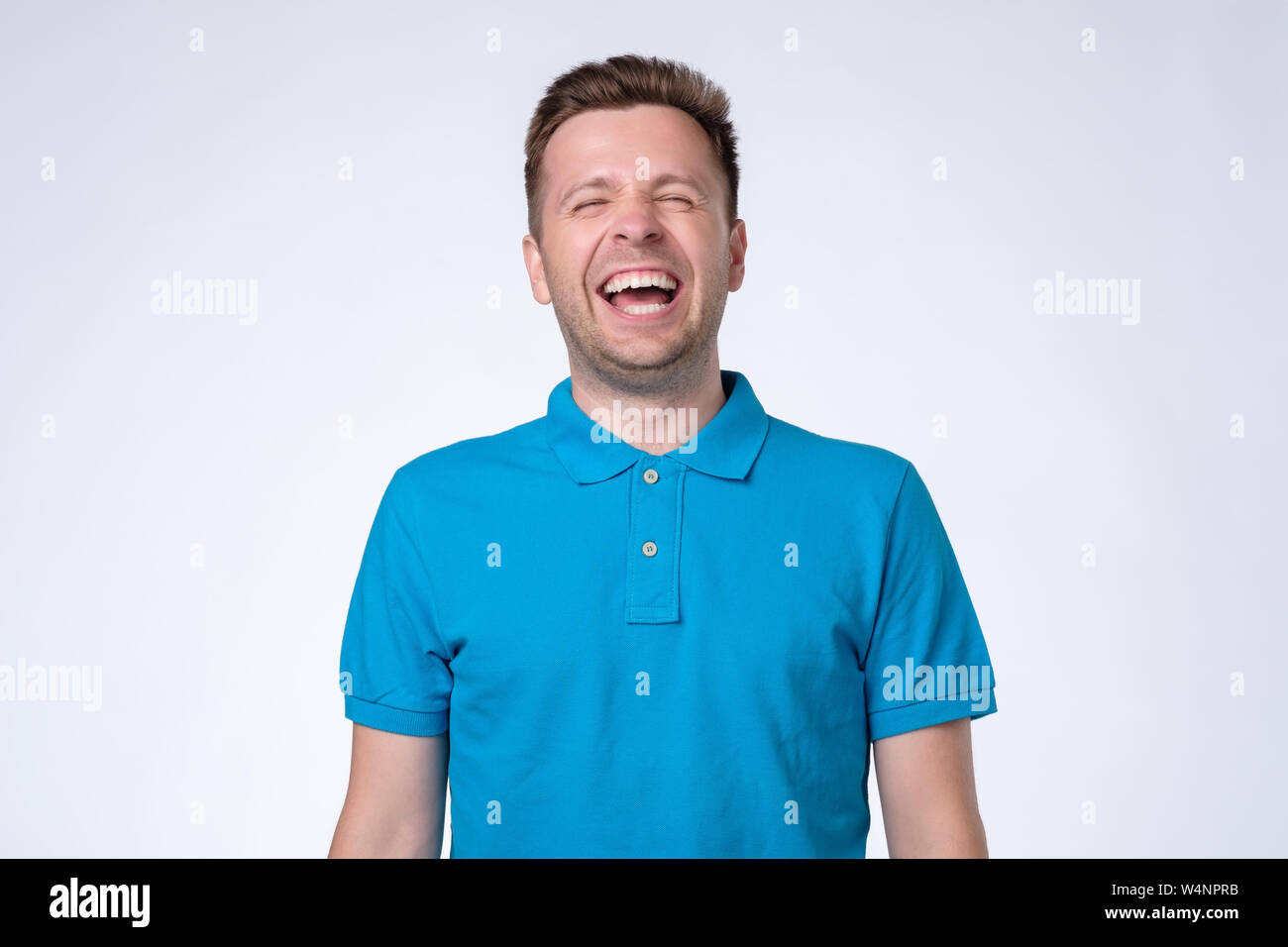 Joyful handsome guy laughing hi-res stock photography and images - Alamy