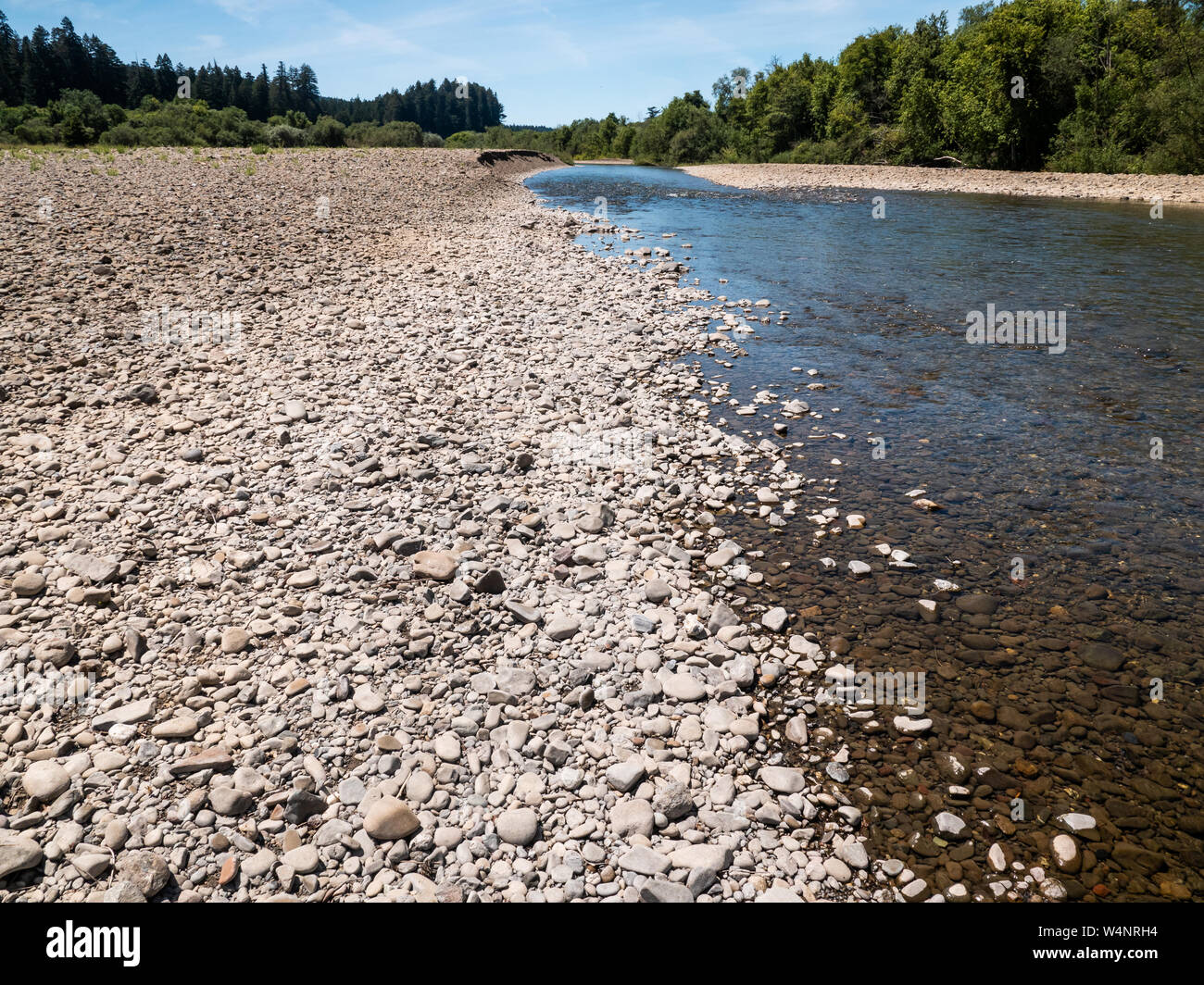 Rocky river bed with shallow river Stock Photo - Alamy