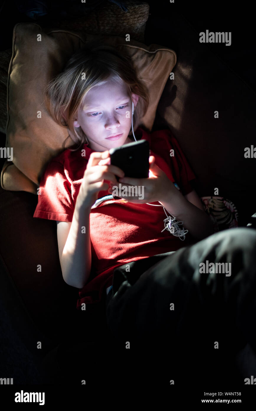 Top down of boy scrolling on smart phone Stock Photo - Alamy