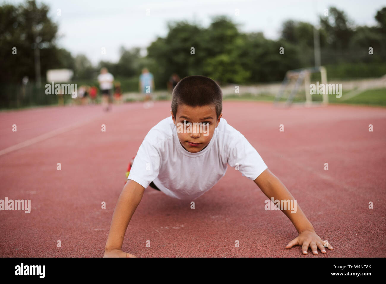 7 year old child is training to pull up on the horizontal bar. Emotions ...