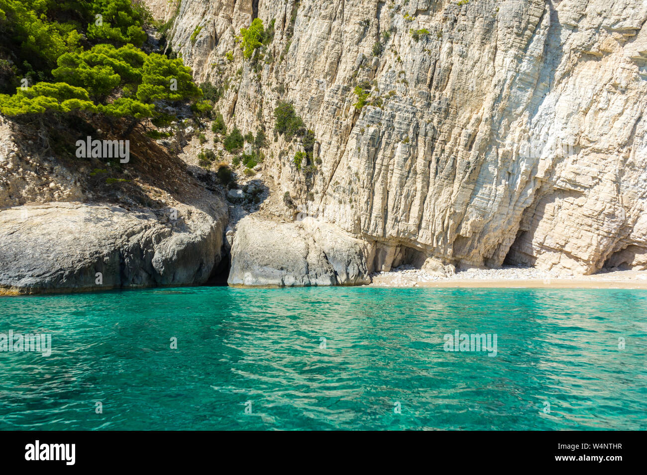 Greece, Zakynthos, White sand beach beneath chalk rock cliffs in remote ...