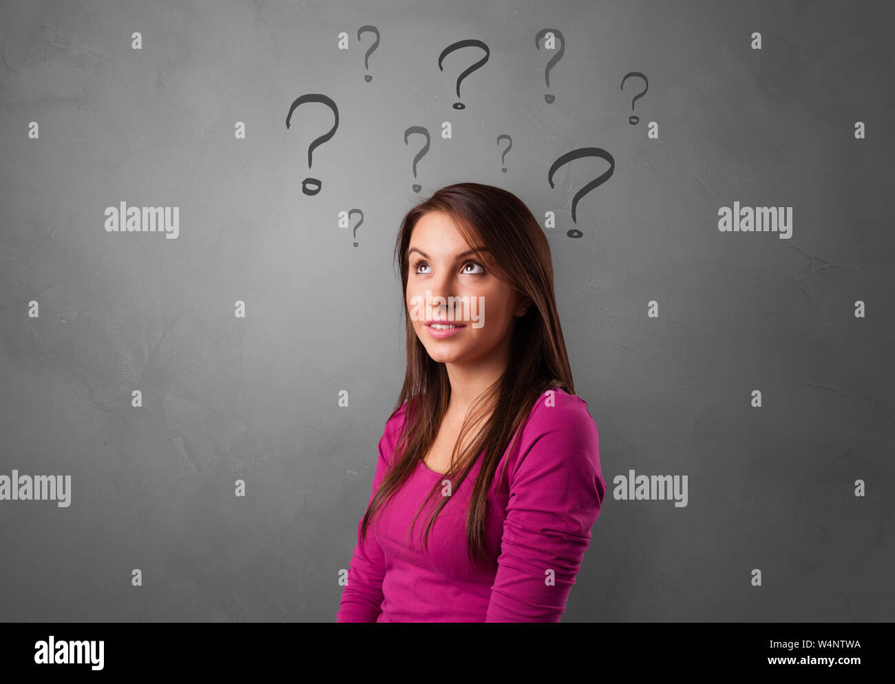 Person with question marks around face Stock Photo - Alamy
