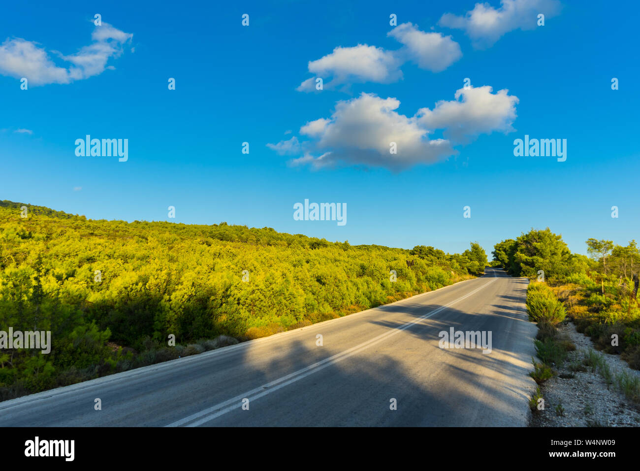 Greece, Zakynthos, Endless highway in untouched green nature landscape ...