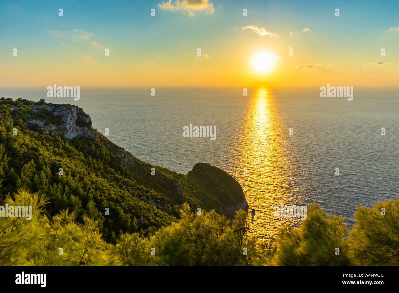 Greece, Zakynthos, Beautiful romantic sunset sky and green cliffs next ...